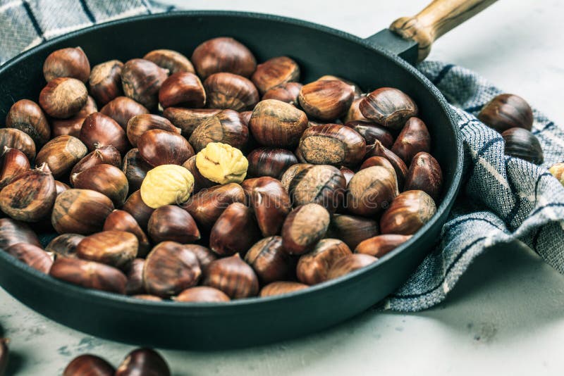 Roasted Chestnuts Served in Chestnut Pan on an Old Table Stock Photo ...