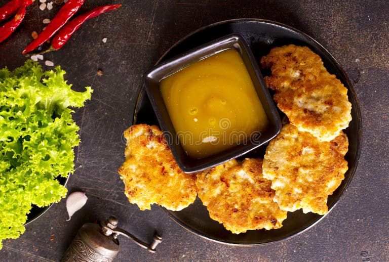 Roasted Chicken Cutlets with Sauce on Black Plate Stock Photo - Image ...