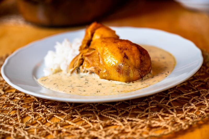 Roasted Chicken Leg with Dill Sauce and Stewed Rice on Plate on Table ...