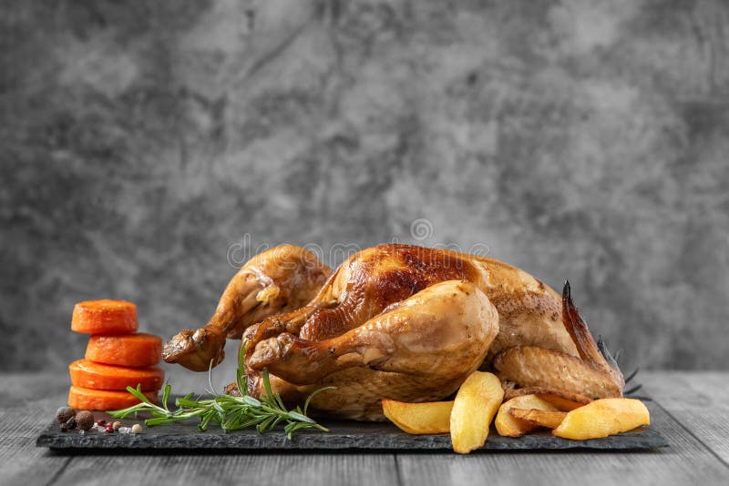 Roasted Chicken, Potatoes and Vegetables on Dark Plate. Side View Stock ...