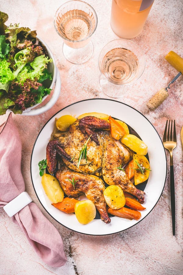 Roasted Chicken with Potatoes, Vegetables and Salad on a Table Stock ...