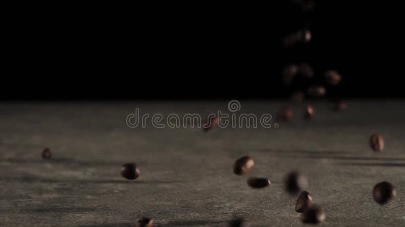 Roasted Coffee Beans Thrown Up from through the White Smoke on Black ...