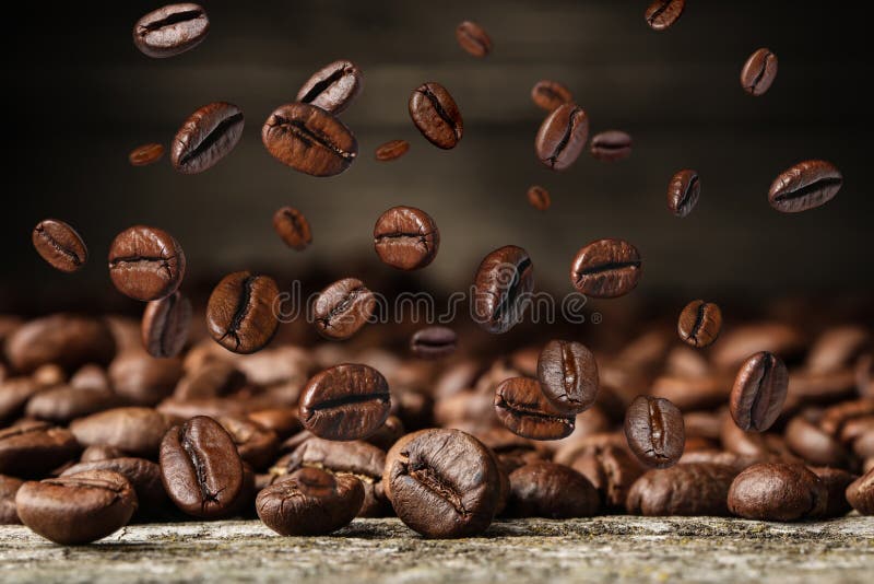Roasted Coffee Beans Falling on Wooden Table, Closeup Stock Image ...
