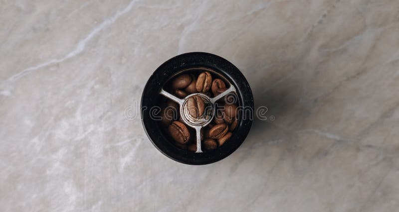 Roasted Coffee Beans Inside Black Hand Grinder Top View on the White ...