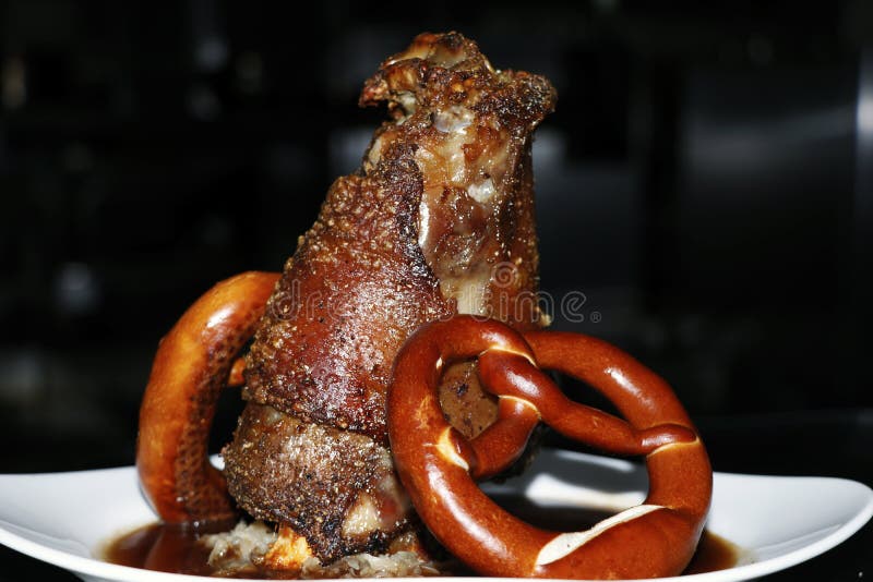Roasted Crispy Pork Knuckle with German Pretzel and Gravy in Close Up ...