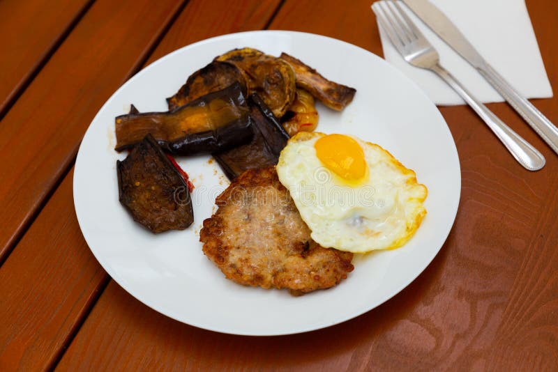 Roasted Cutlet with Fried Egg and Frilled Vegetables Stock Image ...