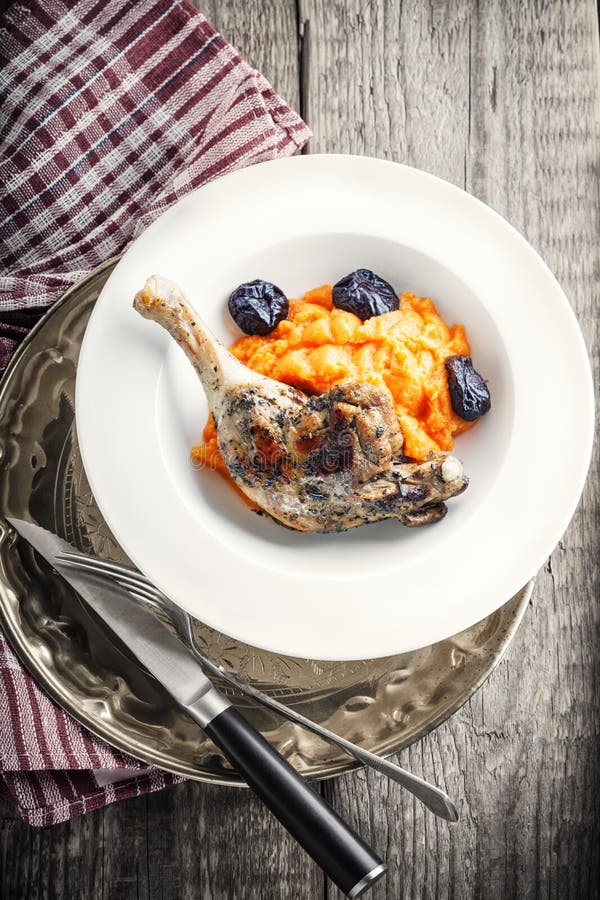 Roasted Duck Leg with Mashed Carrot and Dried Prunes Stock Photo ...