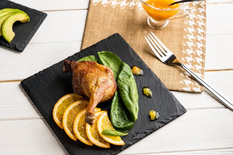 Roasted Duck Leg with Orange Sauce and Spinach Stock Photo - Image of ...