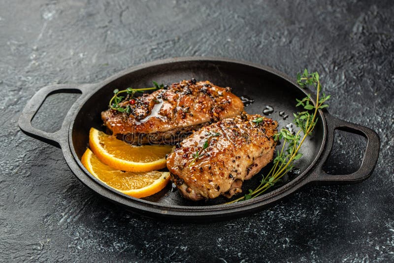 Roasted Duck Meat Steak with Oranges and Thyme in a Pan. on a Dark ...