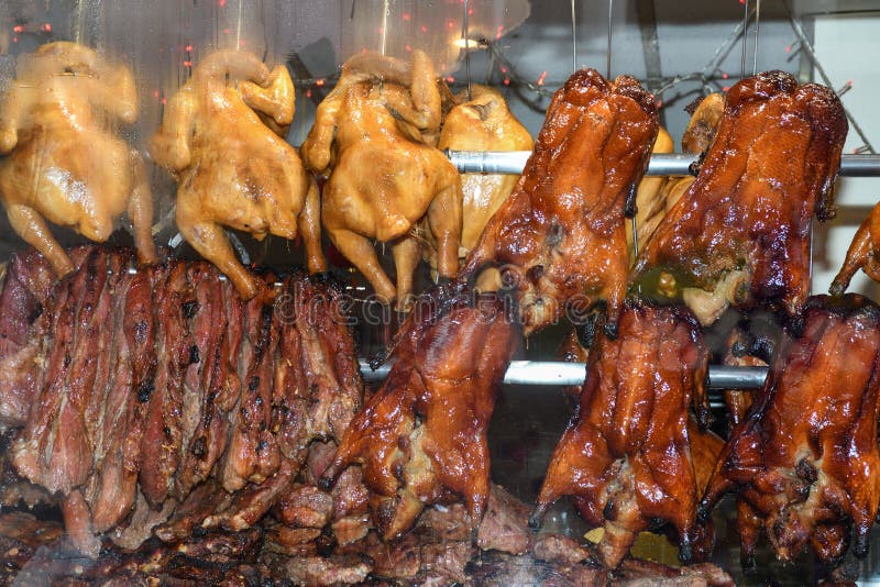 Roasted Ducks and Ribs Hanging on Rack Showcase in Restaurant`s Kitchen ...