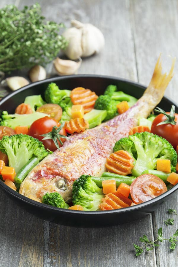 Roasted Fish with Vegetables Stock Photo - Image of cherry, broccoli ...