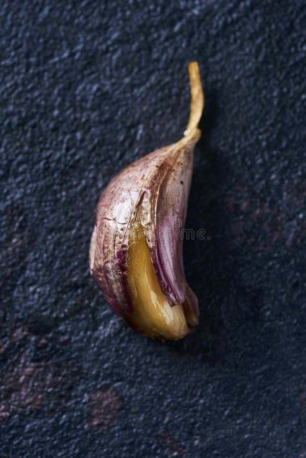 Roasted Garlic on a Black Stone Surface Stock Image - Image of ...