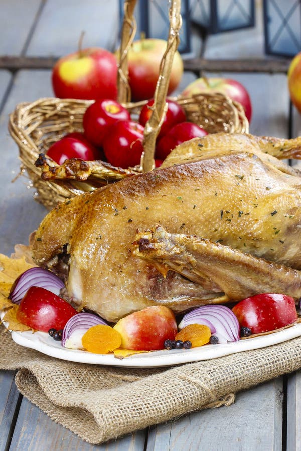 Roasted Goose with Apples and Vegetables on Wooden Table. Stock Image ...