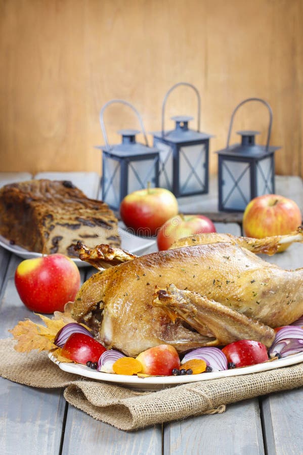 Roasted Goose with Apples and Vegetables on Wooden Table. Stock Photo ...