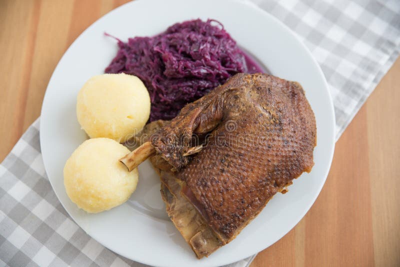 Roasted Goose Leg with Braised Red Cabbage Stock Photo - Image of ...