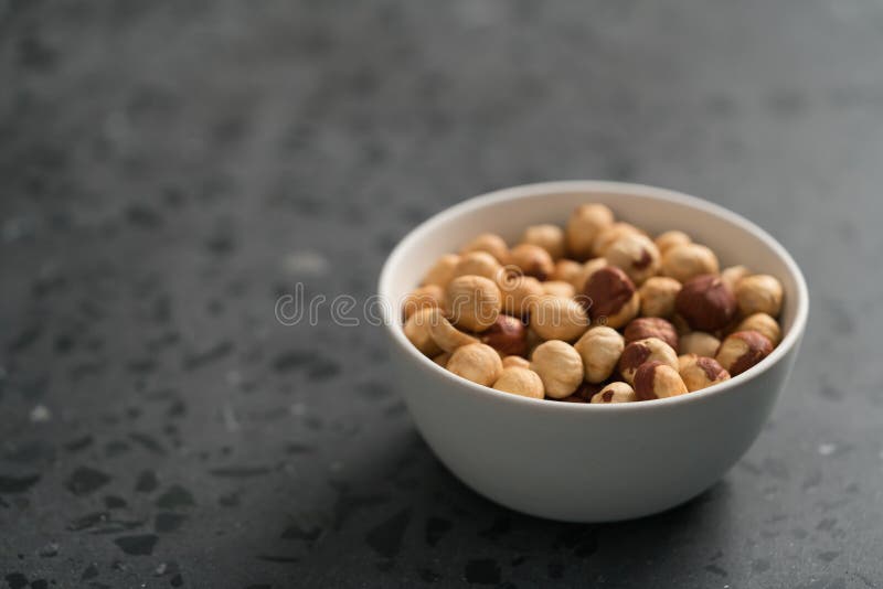 Roasted Hazelnuts in White Bowl on Concrete Background Stock Photo ...