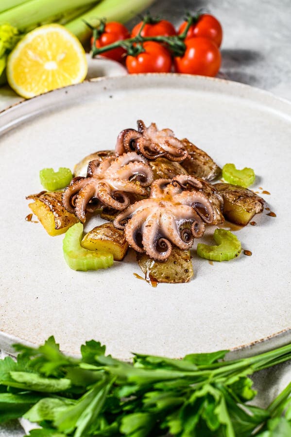 Roasted Octopus with Potatoes and Celery. Gray Background. Top View ...