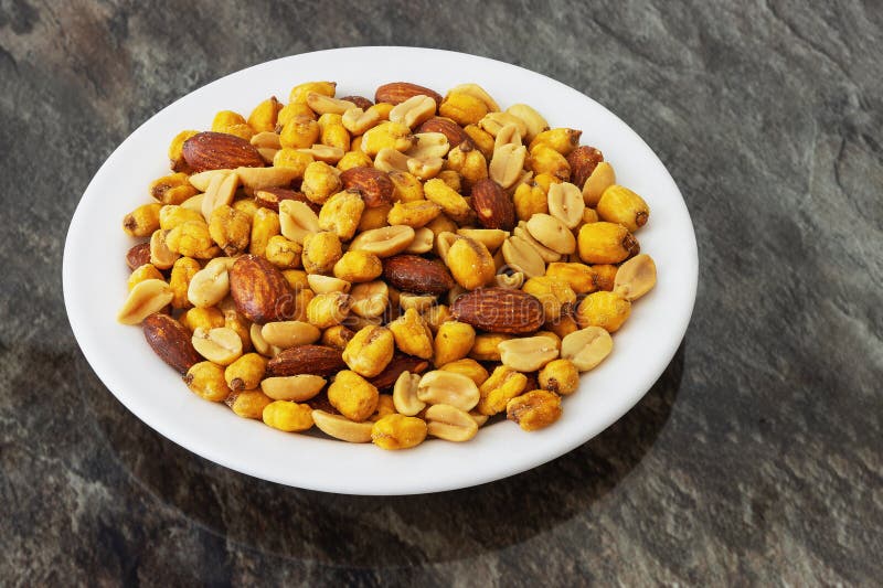 Roasted Peanuts, Corn and Almonds in a Plate on the Table Stock Image ...