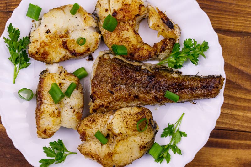 Roasted Pollock in White Plate on Wooden Table Stock Image - Image of ...