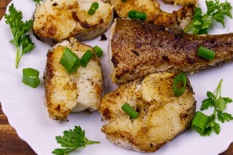 Roasted Pollock in White Plate on Wooden Table Stock Image - Image of ...