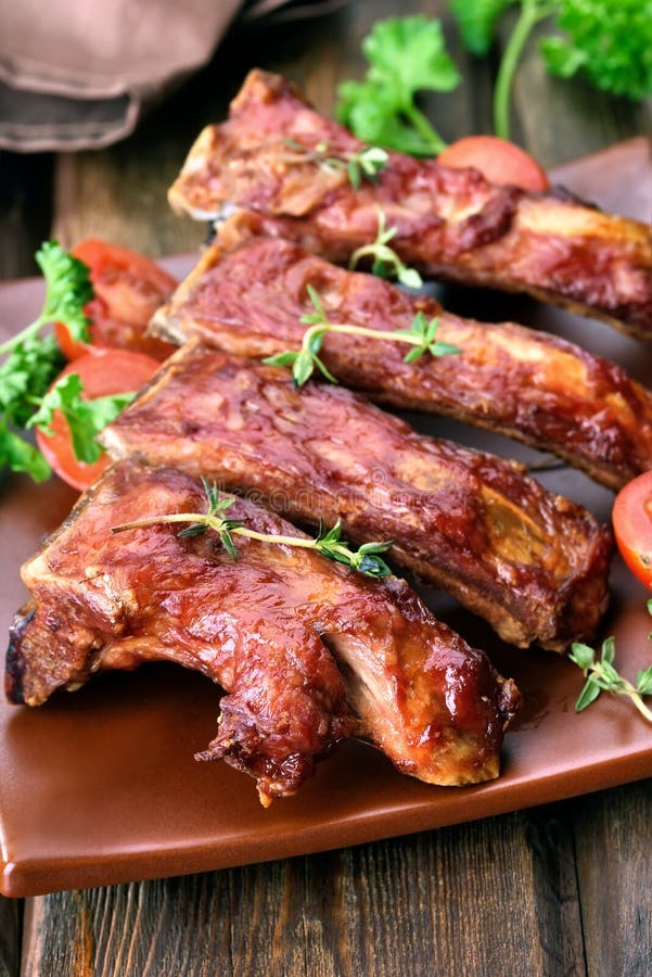 Roasted pork ribs on plate stock image. Image of green - 65931647