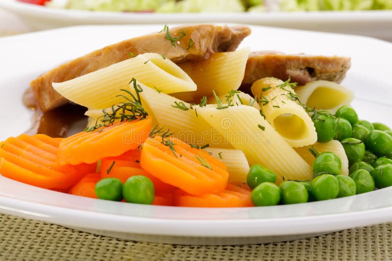 Roasted Pork Shoulder Served with Pasta and Vegetables Stock Image ...
