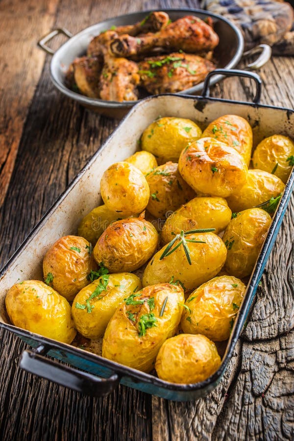 Roasted Potatoes with Herbs in Pan on Rustic Oak Table Stock Photo ...