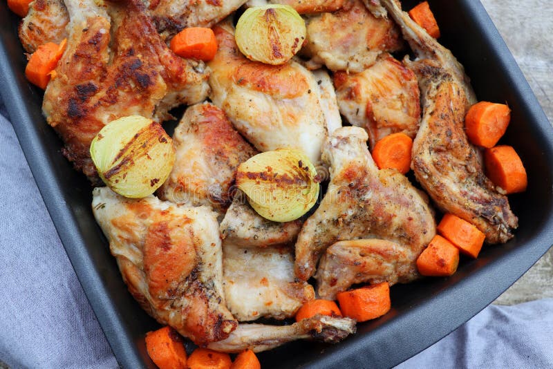 Roasted Rabbit Haunches in Pan with Stewed Vegetables on Rustic Wooden ...