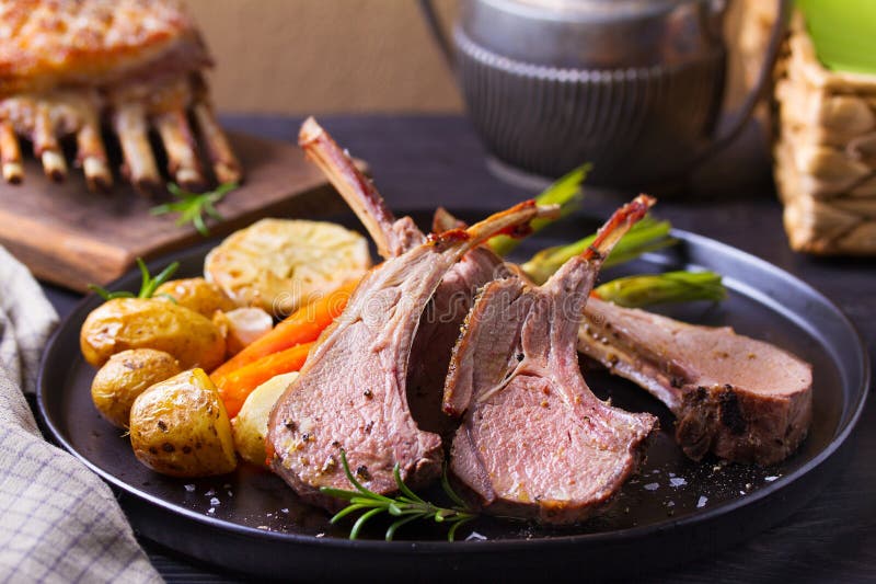Roasted Rack of Lamb. Lamb Chops with Vegetables on Black Plate. Stock ...