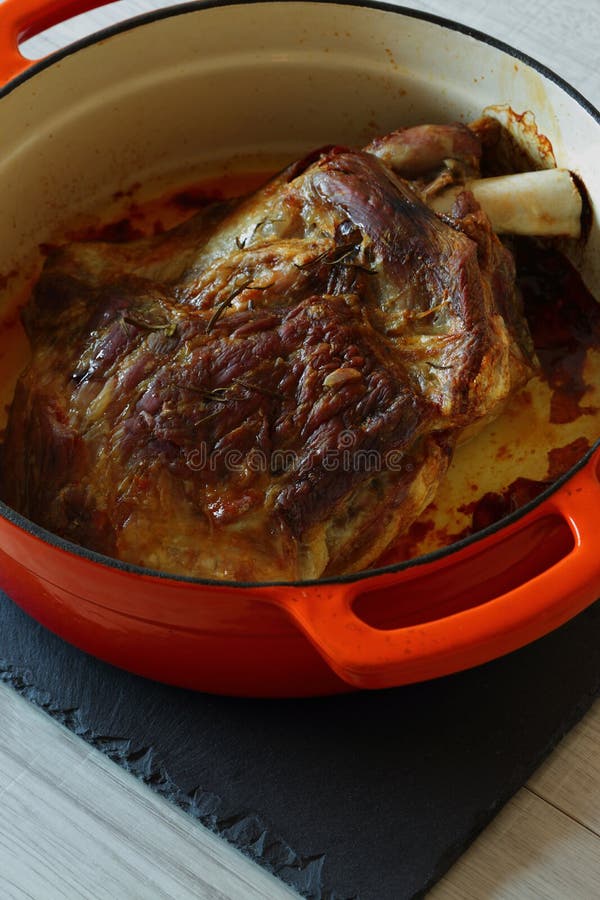 Roasted Shoulder of Lamb in an Orange Ceramic Roasting Dish after ...