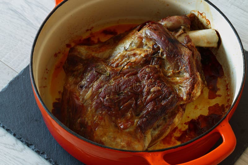Roasted Shoulder of Lamb in an Orange Ceramic Roasting Dish after ...