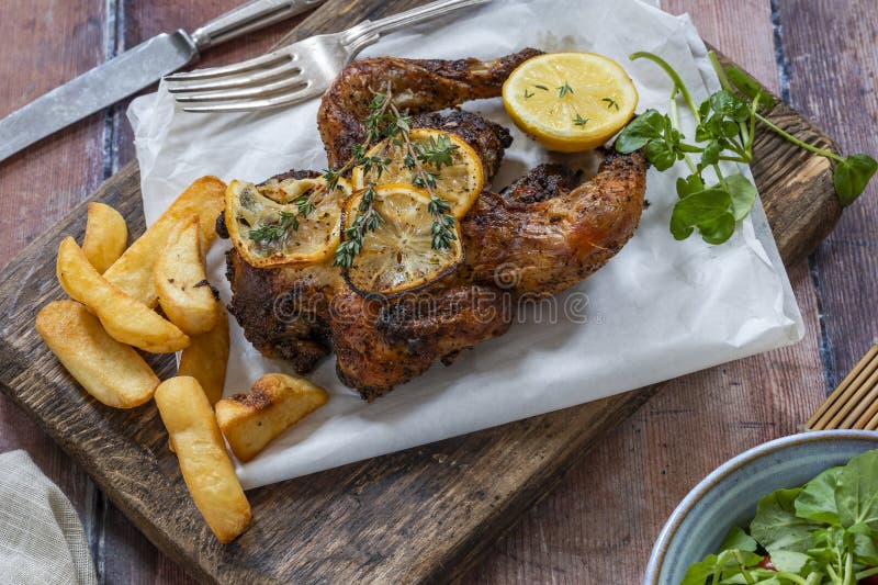 Roasted spatchcock poussin stock photo. Image of chips - 361267584