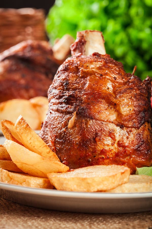 Roasted Turkey Knuckle with Fried Potato Slices Stock Image - Image of ...
