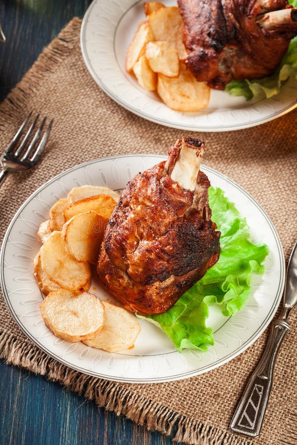 Roasted Turkey Knuckle with Fried Potato Slices Stock Image - Image of ...