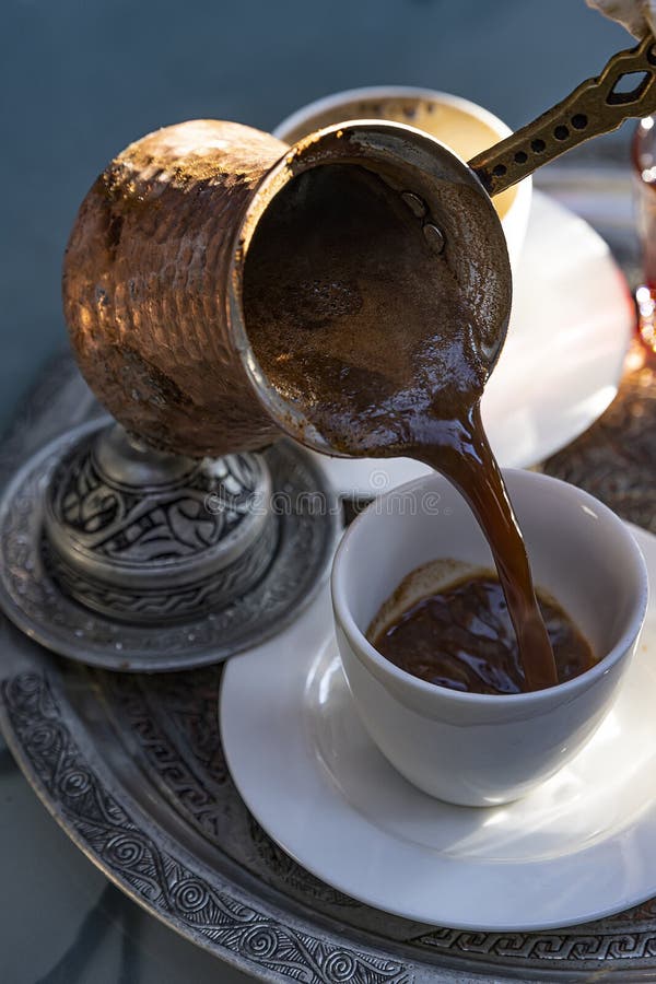 Roasted Turkish Coffee. Pouring of Hot Coffee from Cezve into Cup on ...