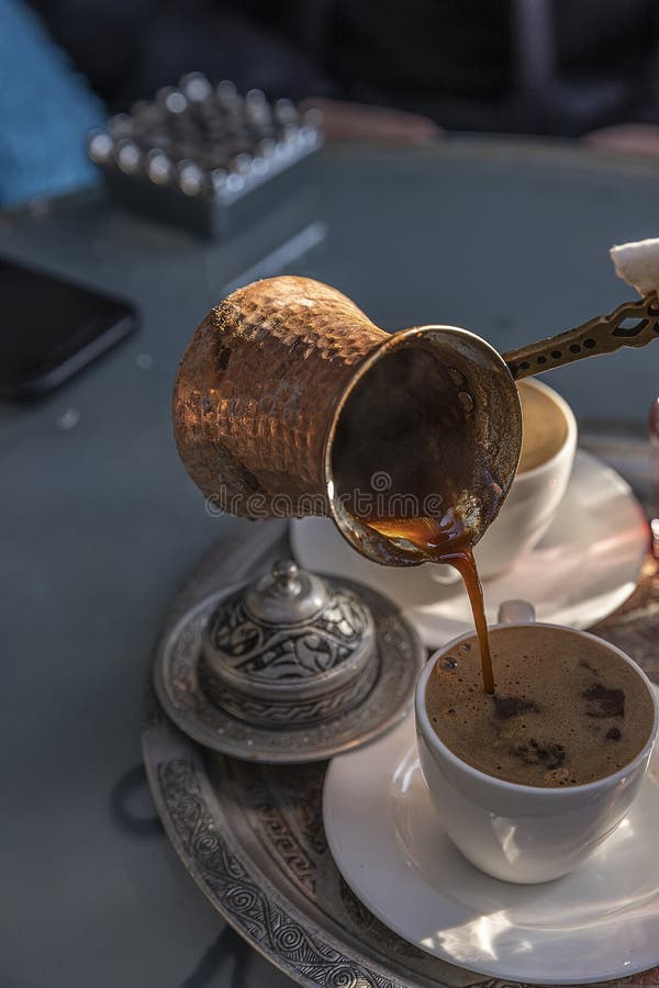 Roasted Turkish Coffee. Pouring of Hot Coffee from Cezve into Cup on ...