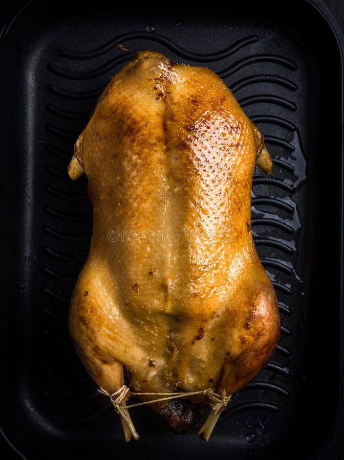 Roasted Whole Duck on Black Baking Tray Stock Photo - Image of grilled ...