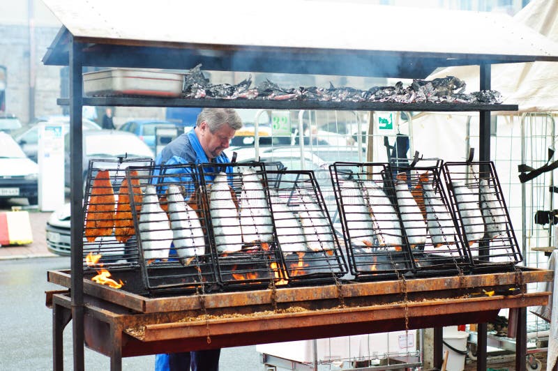 Roasting fish on open fire editorial stock photo. Image of morning ...