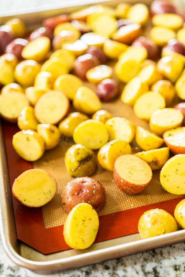 Roasting Halved Mixed Marble Potatoes in Modern Kitchen Stock Photo ...