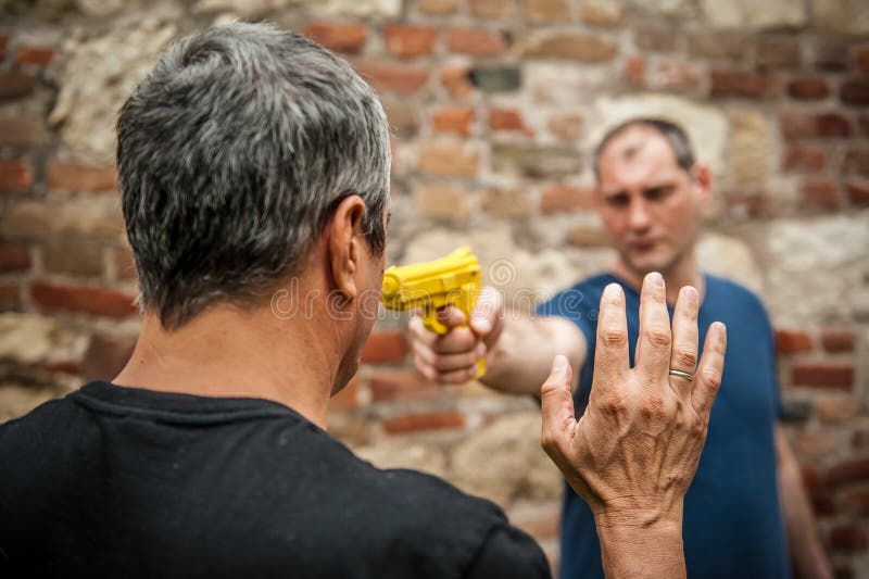 Robber with a Gun Attacks the Victim. Gun Point Stock Photo - Image of ...