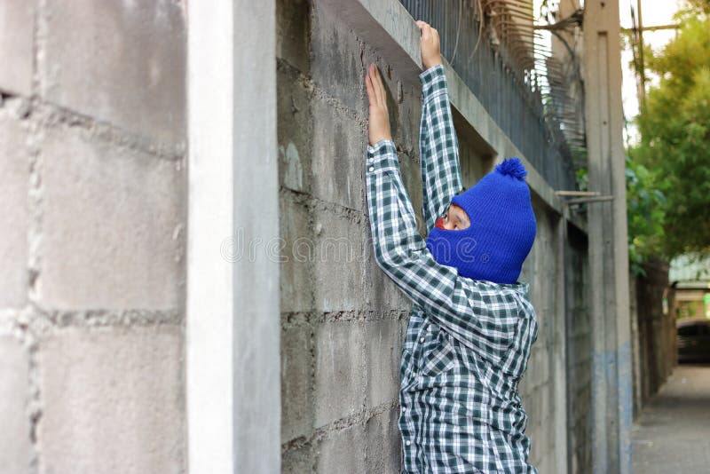 Robber Mask Climbing Fence Stock Photos - Free & Royalty-Free Stock ...