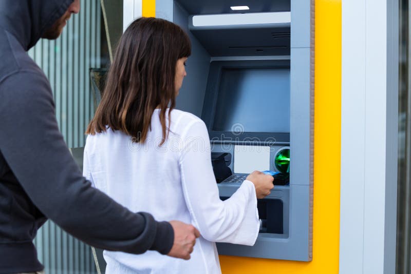 Robber Snatching Card from Woman`s Hand Using ATM Stock Photo - Image ...