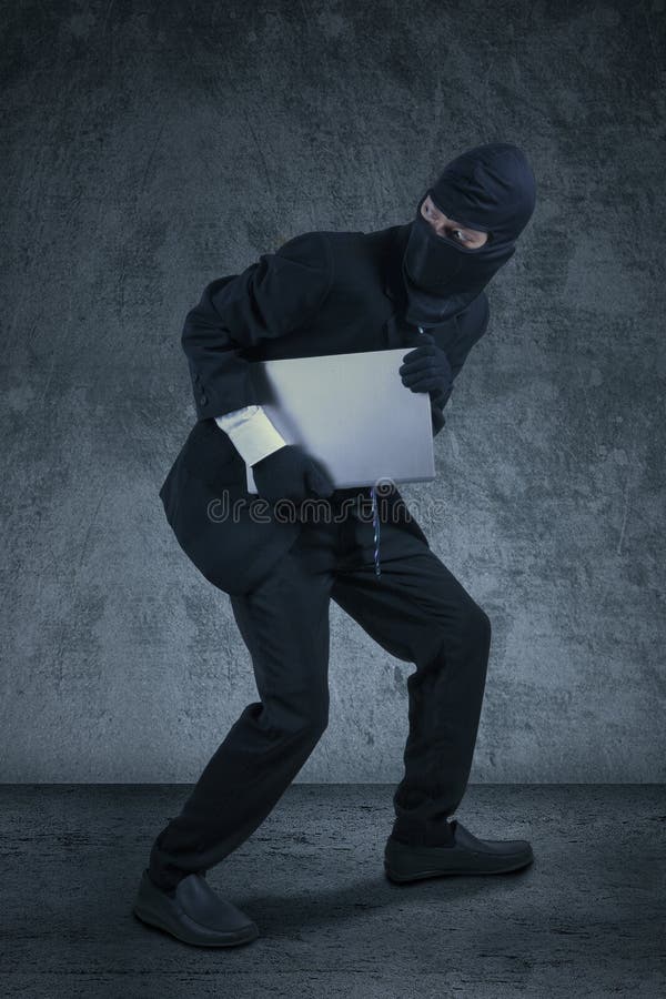 Robber Stealing Notebook Computer Stock Photo - Image of crime, male ...