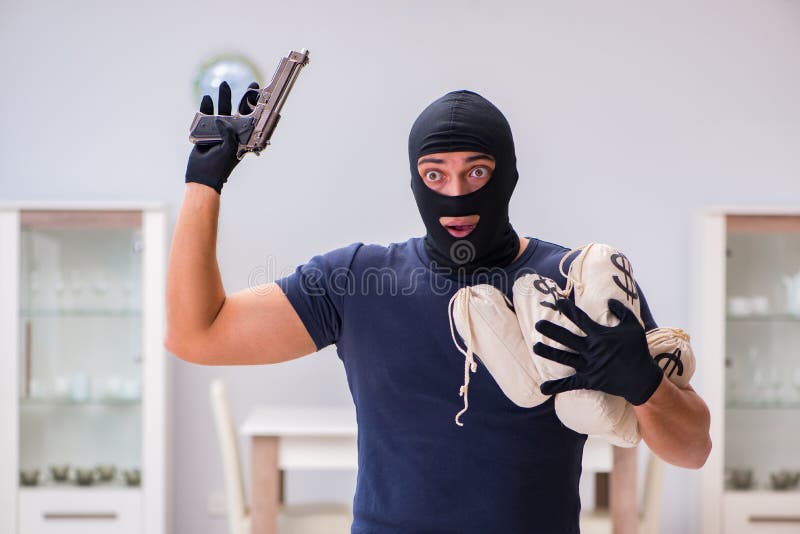 The Robber Wearing Balaclava Stealing Valuable Things Stock Photo ...