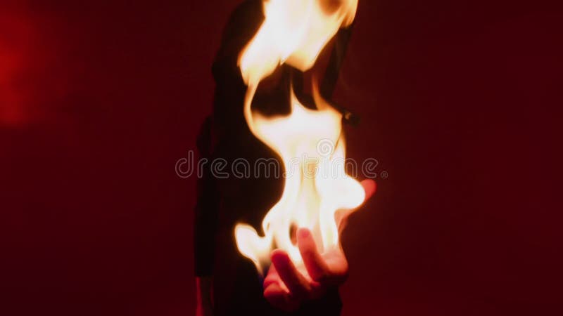 A Robed Wizard with a Sword on His Back Holds a Burning Hand in Front ...