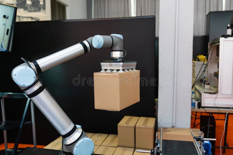 Robot Arm Moves Box in an Automatic Warehouse Stock Image - Image of ...