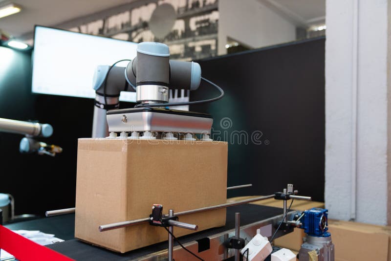 Robot Arm Moves Box in an Automatic Warehouse Stock Image - Image of ...