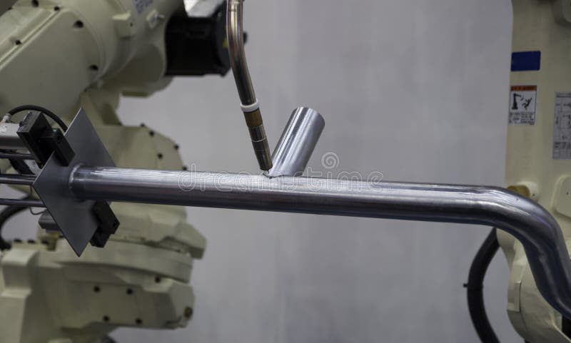 Robot arm welding pipe stock photo. Image of sparks - 114564412