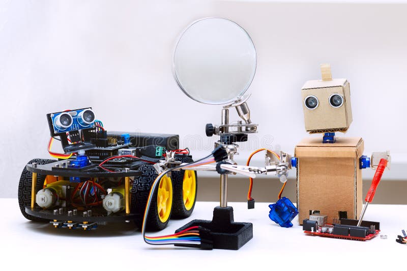 Robot with Arms and Robot with Wheels are on the Table Stock Photo ...