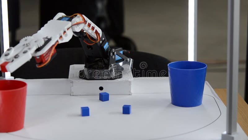 Robot Automatic Hand Taking Cubes and Putting in Glass. Automatic ...